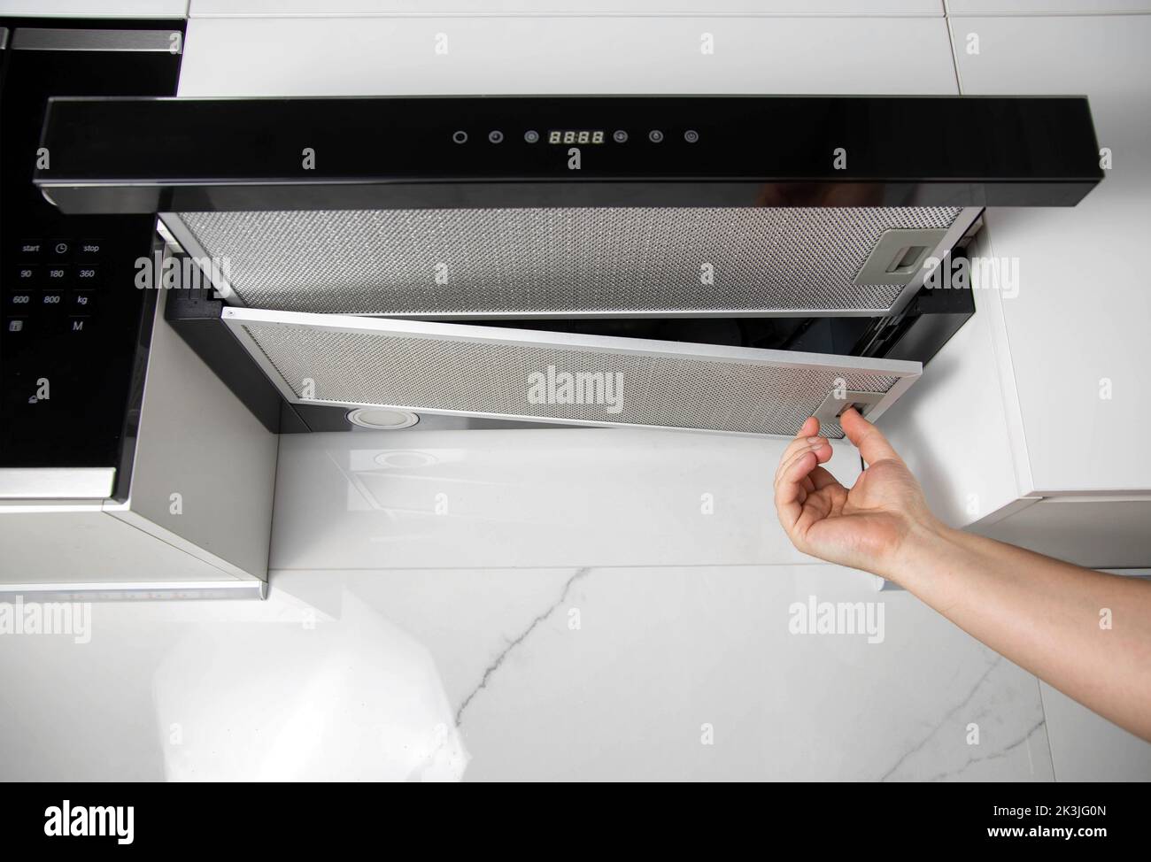 replacement of the grease filter in the kitchen hood Stock Photo - Alamy