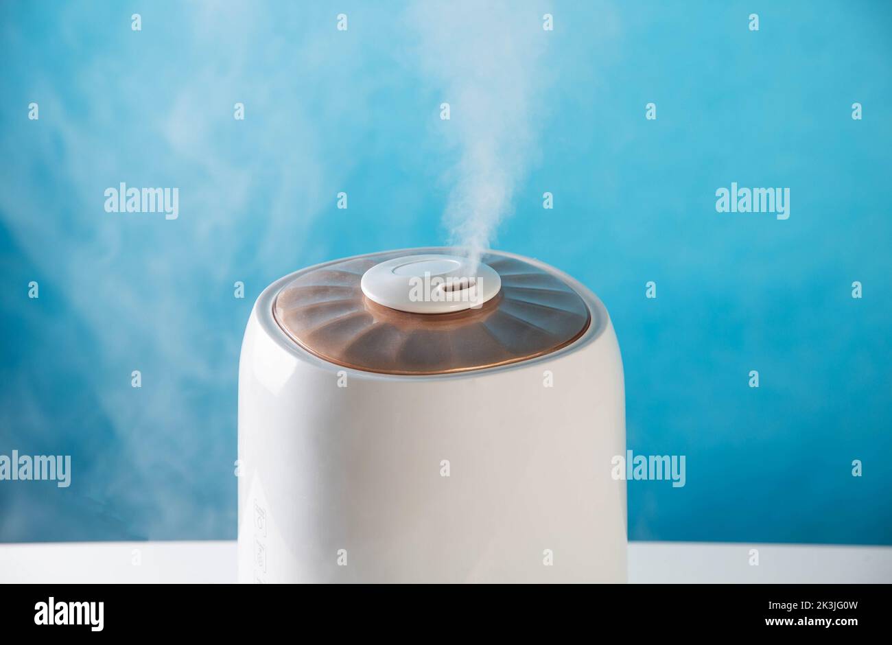Modern air humidifier on a blue background. Humidification in the room ...