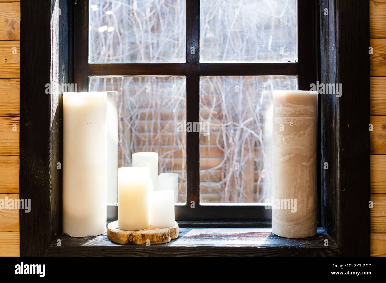 Christmas, winter, New Year Eve concept. Candles at the window. Snowy ...