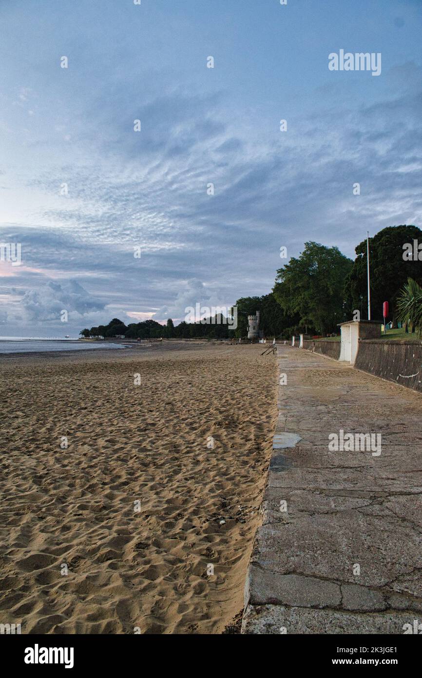 A scenic view of the shore of a beach where the tower of Appley tower ...