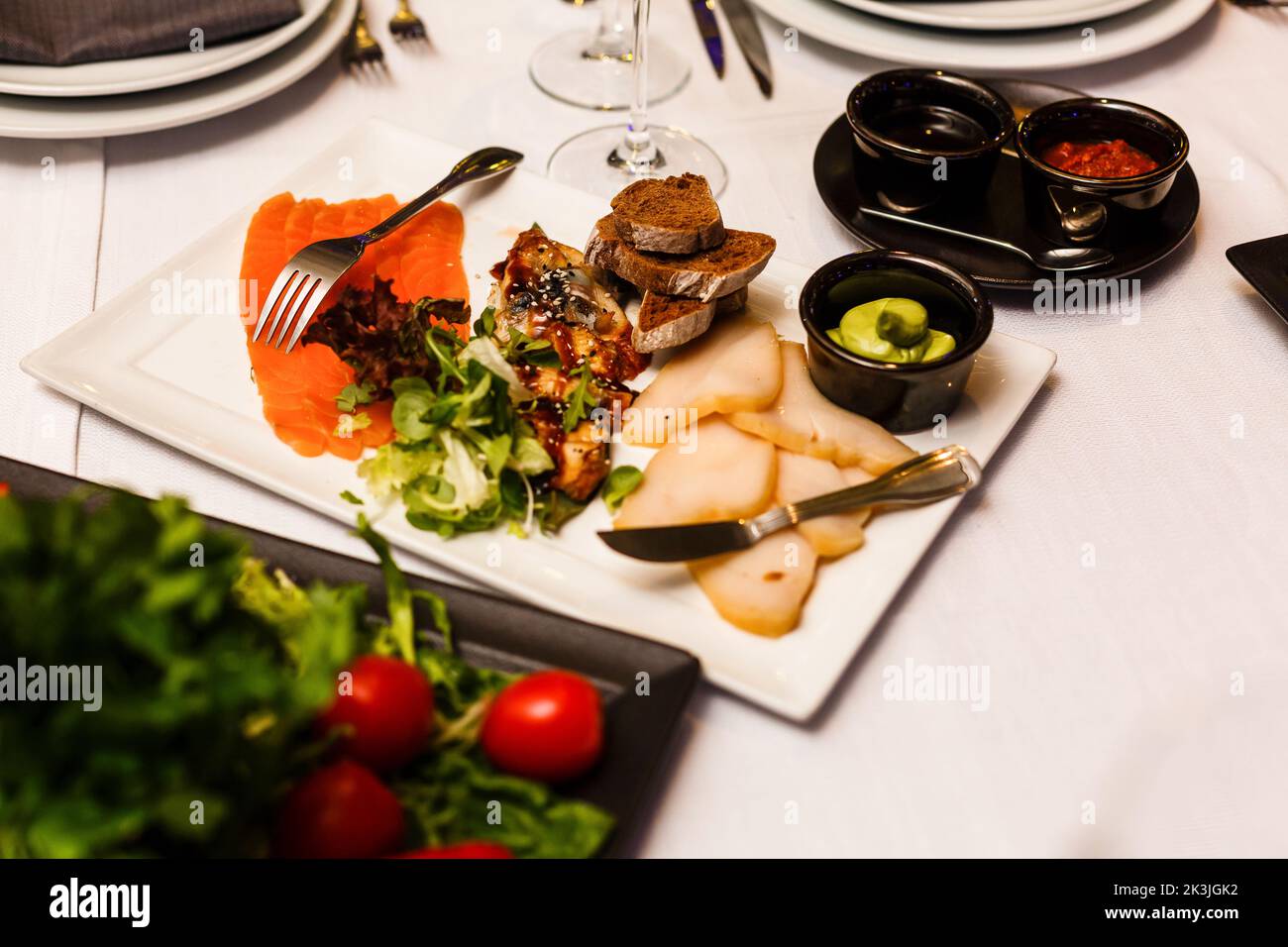Fish platter in restaurant. Slices of salmon fish, smoked eel, white ...