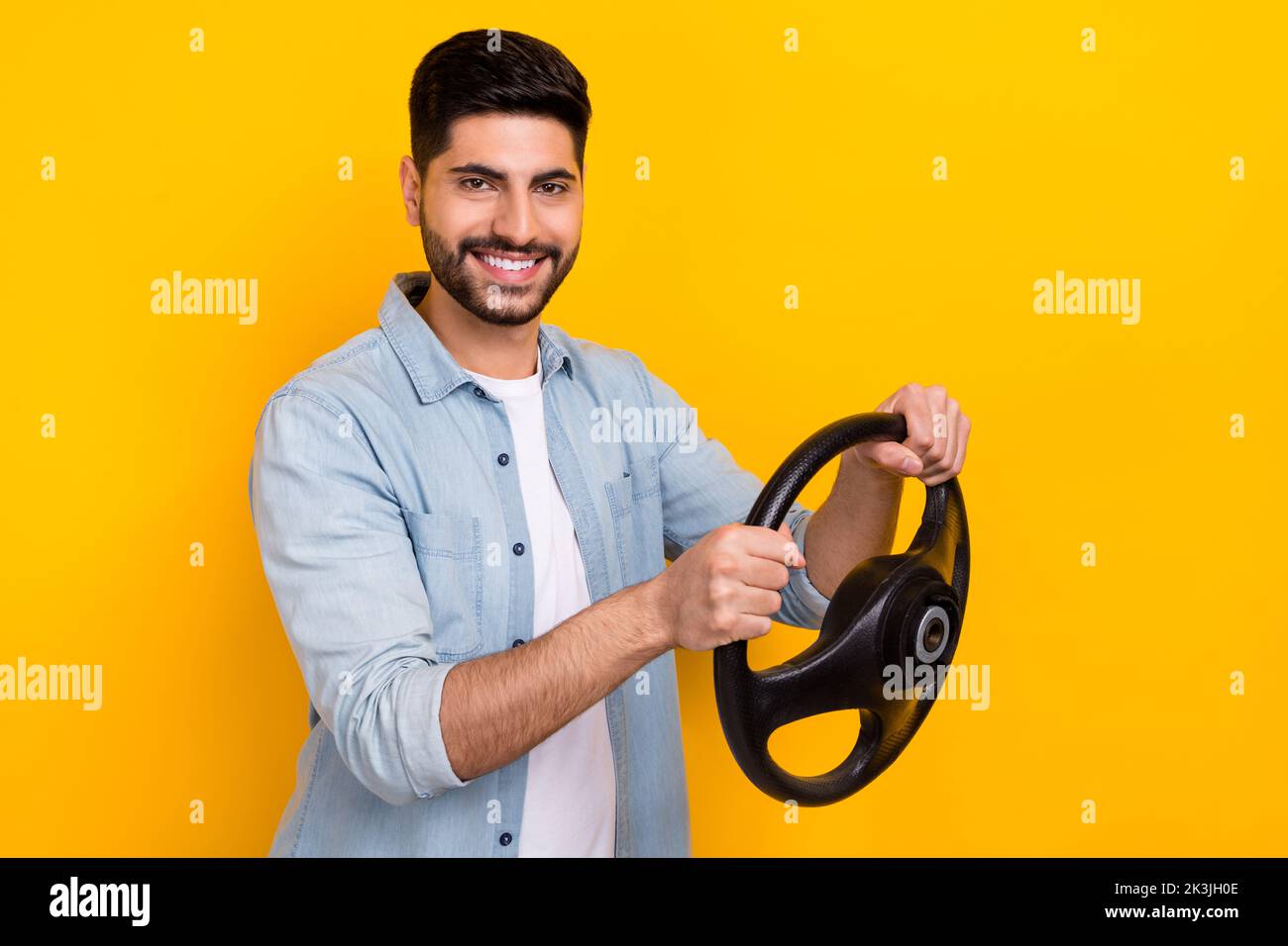 Photo of young smiling confident guy playing videogame driving car test ...