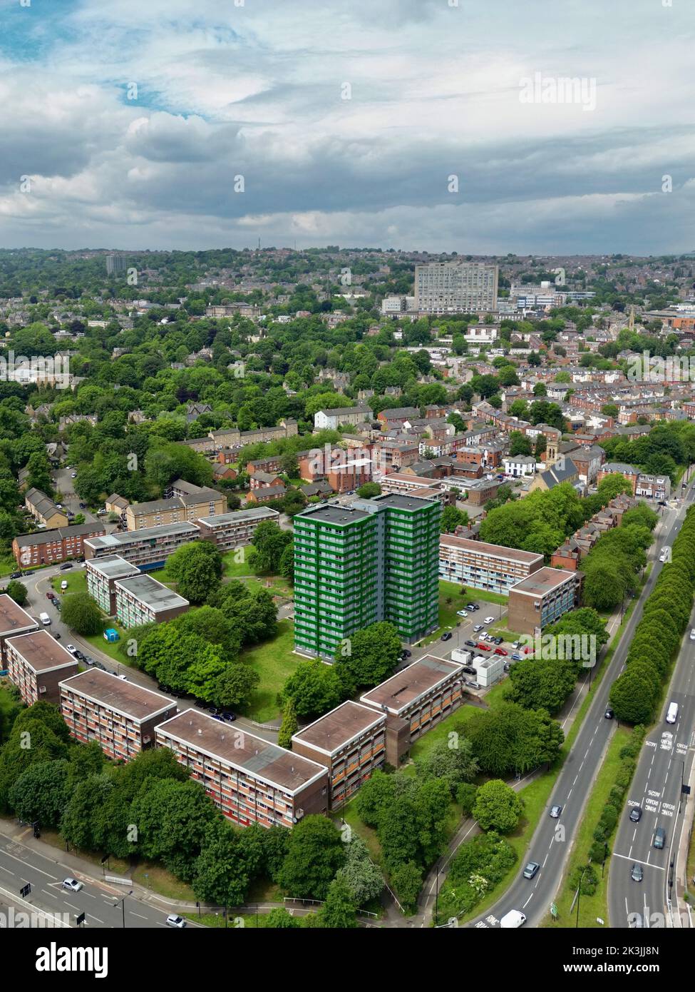 A vertical high-angle drone shot of Sheffield with tall green ...