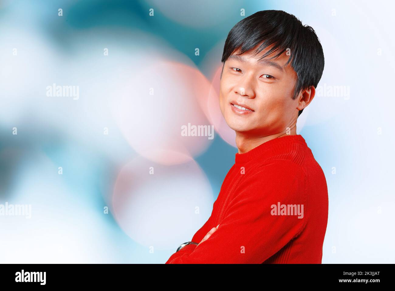 Handsome young asian man smiling Stock Photo - Alamy