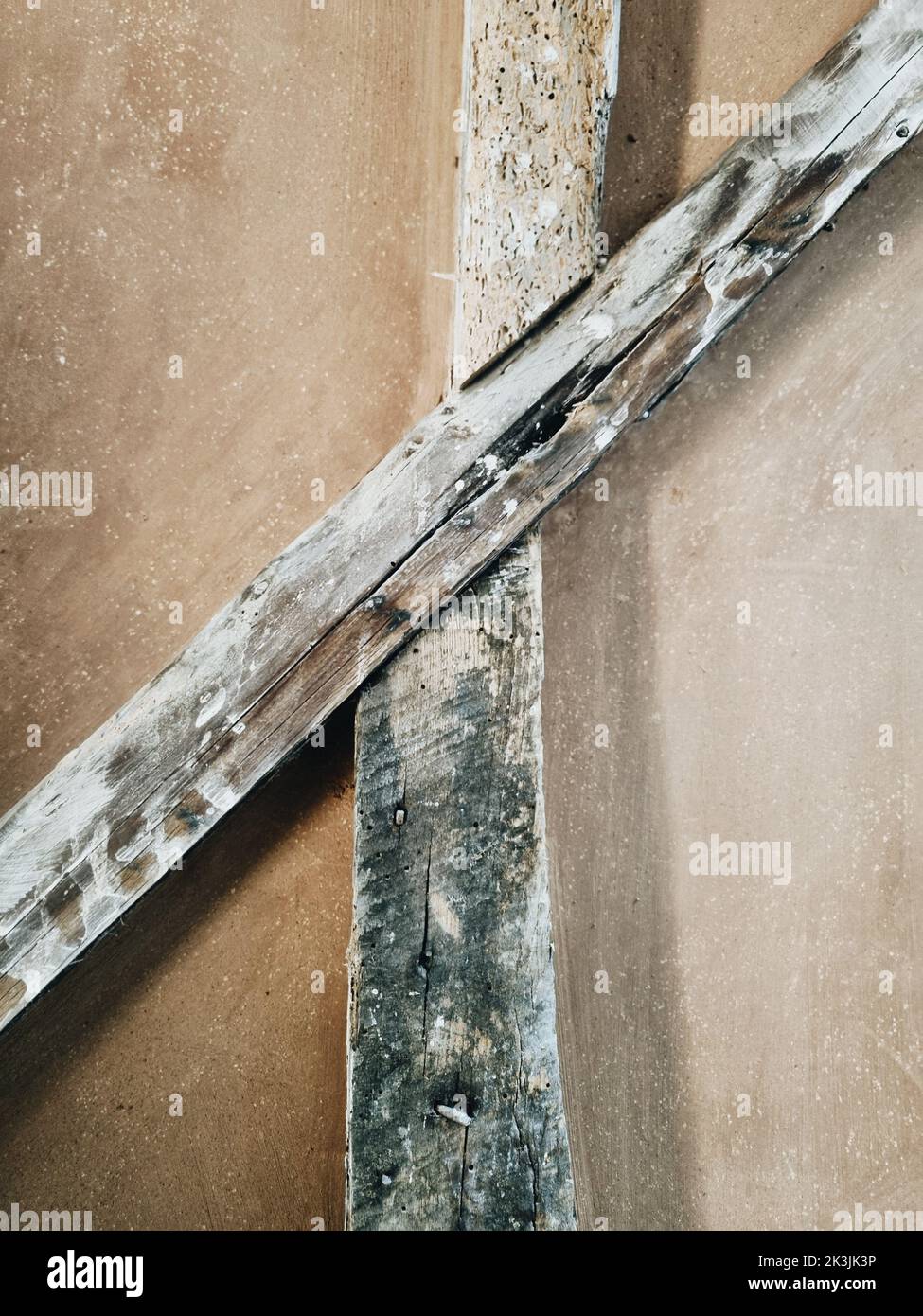 A vertical shot of crossed wood timbers on a smooth surface Stock Photo ...