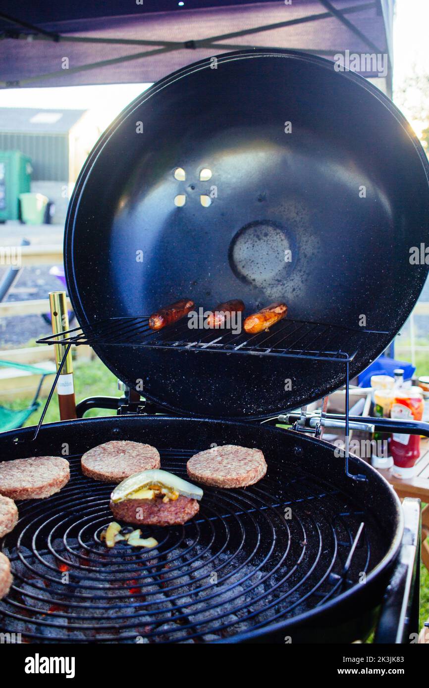 A vertical shot of Burgers cooking on a BBQ Stock Photo - Alamy