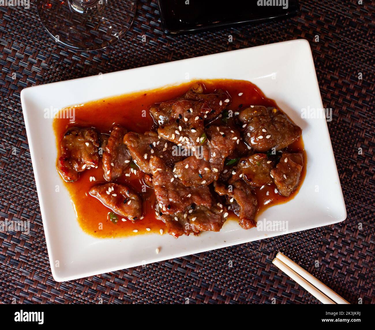 Japanese dish - wok with veal and sesame seeds Stock Photo - Alamy