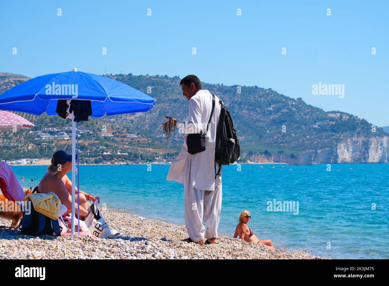 A man selling various things on the beach Stock Photo - Alamy