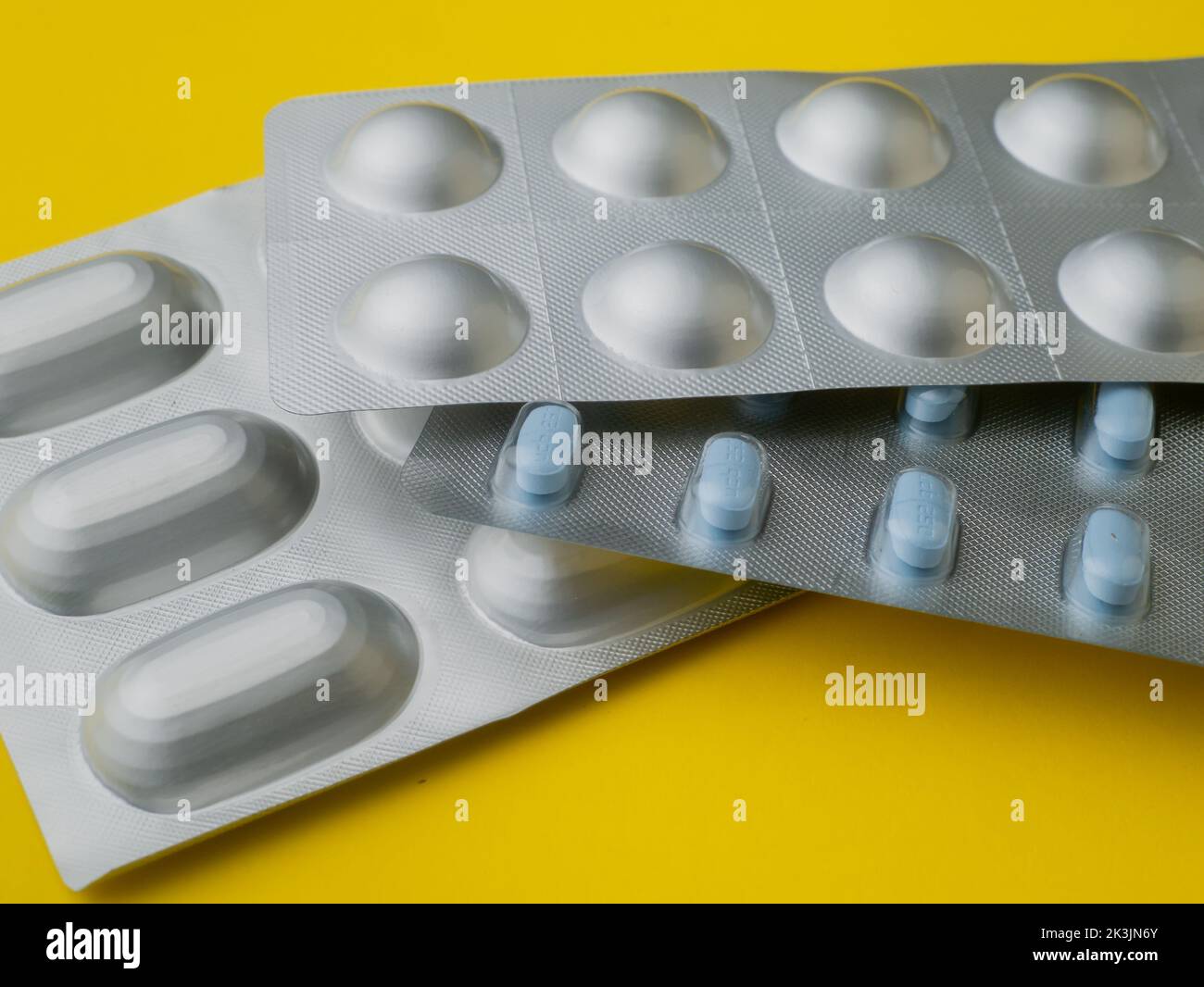 Close Up Of Different Tablet Blisters On Yellow Background Stock Photo ...