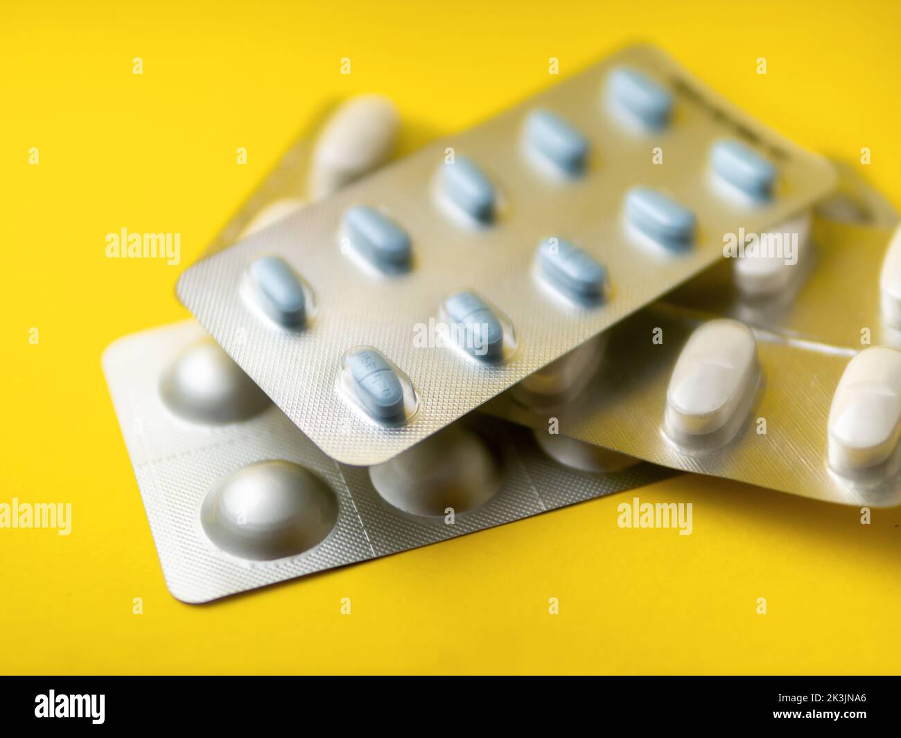 Different Tablet Blister On Yellow Background Stock Photo - Alamy