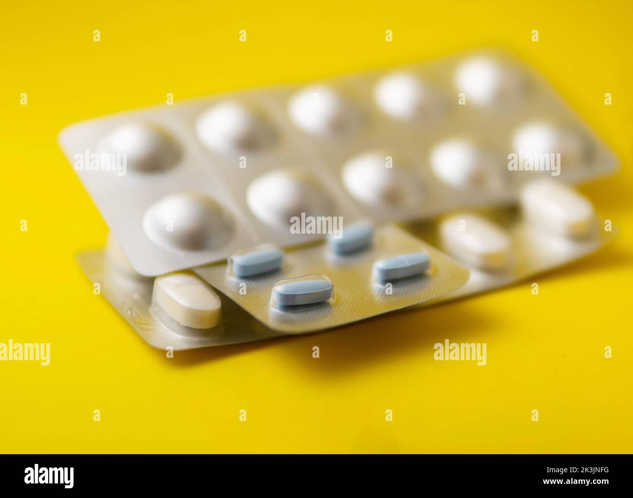 Different Tablet Blisters On Yellow Background Stock Photo - Alamy
