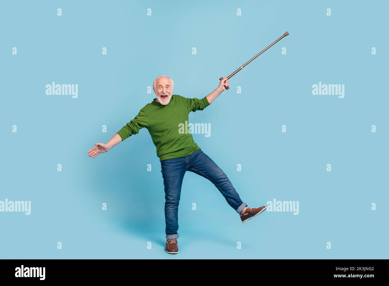 Full size portrait of overjoyed satisfied funny granddad hold stick ...