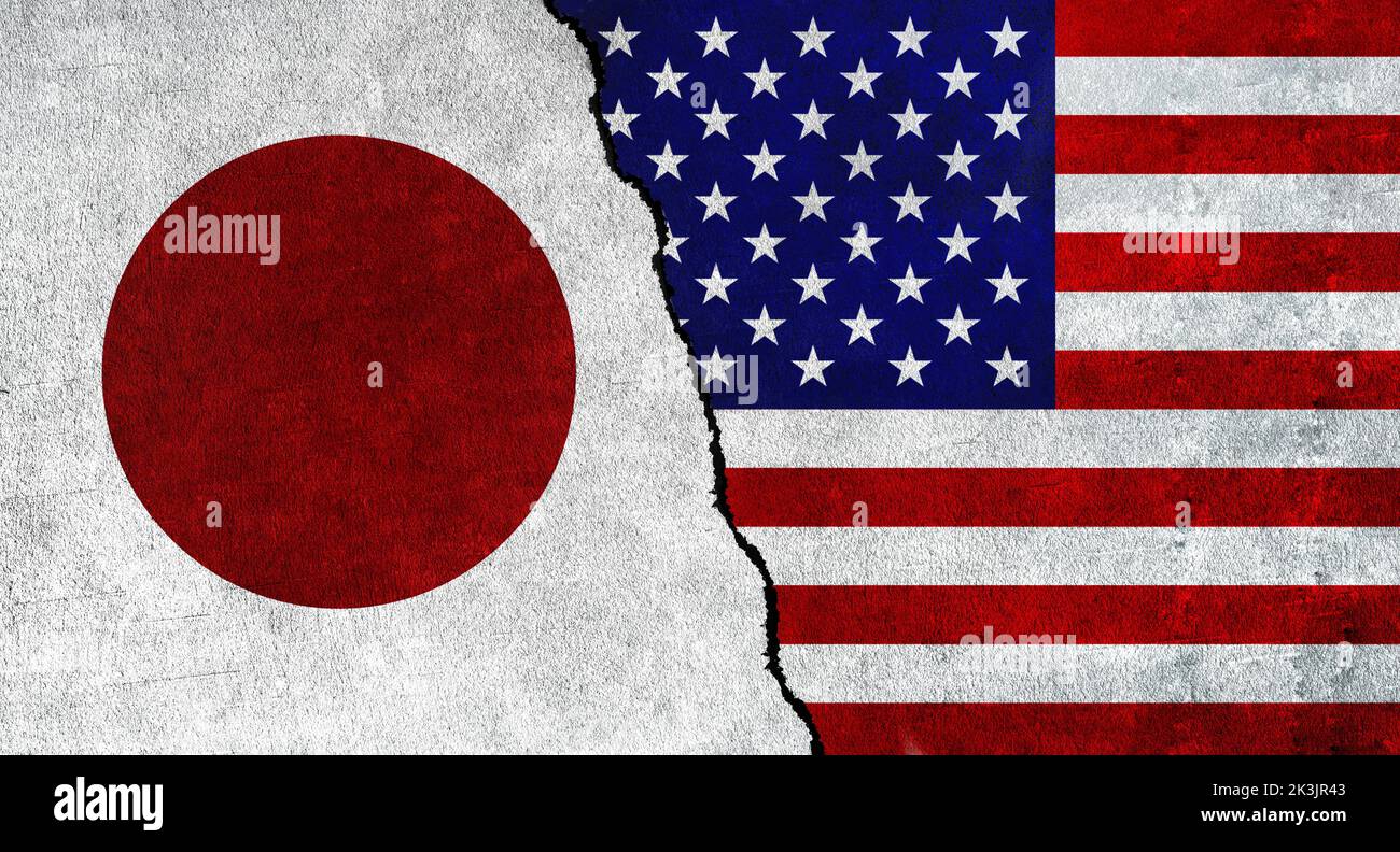 USA and Japan painted flags on a wall with a crack. United States of ...