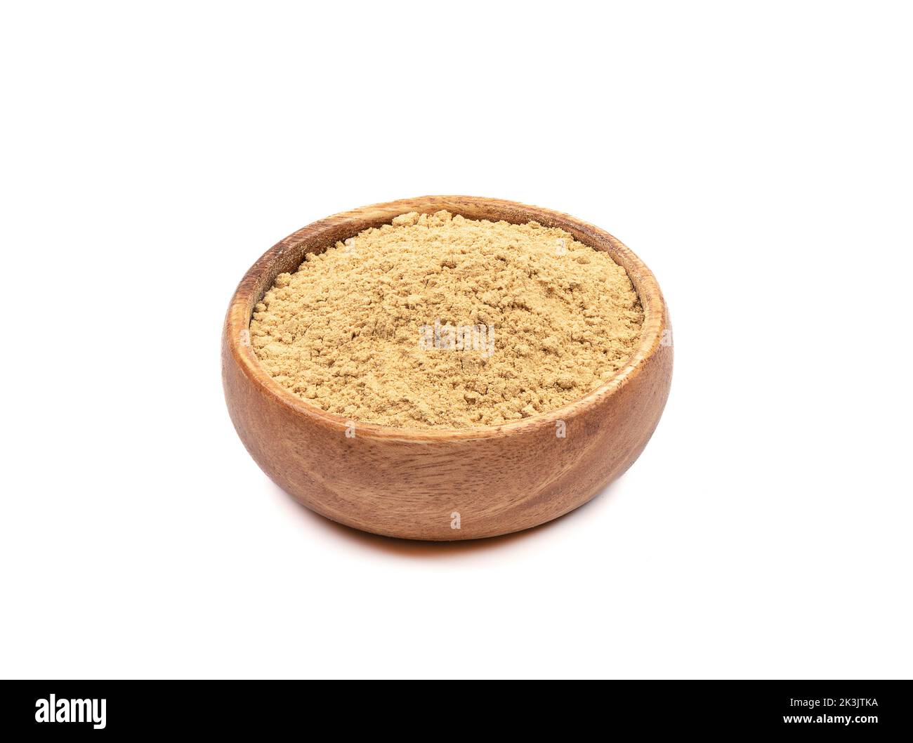 Wooden bowl with ground ginger root powder over white background. Copy ...