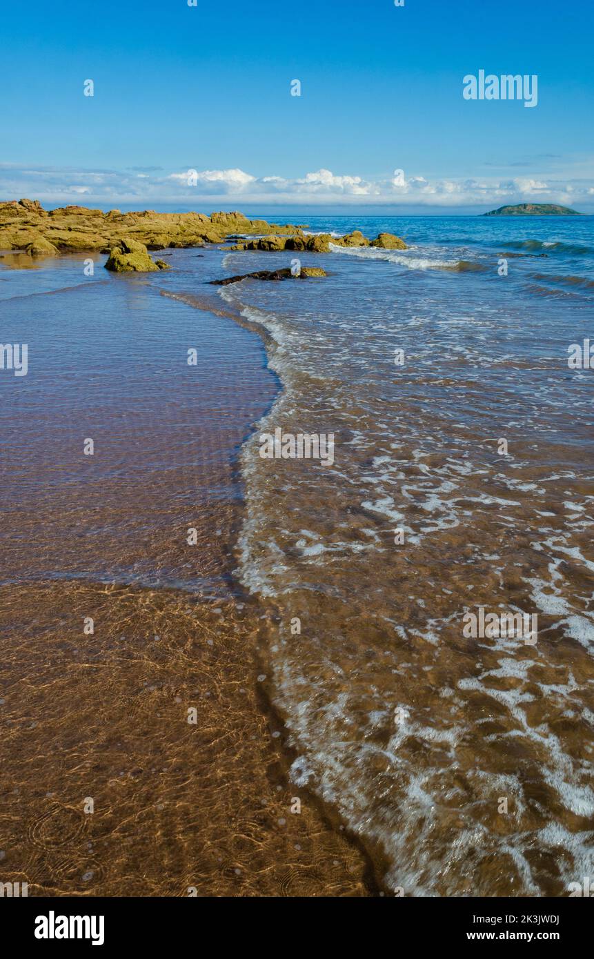 Waves breaking on sandy beach with ripples and rocks at Southend near ...