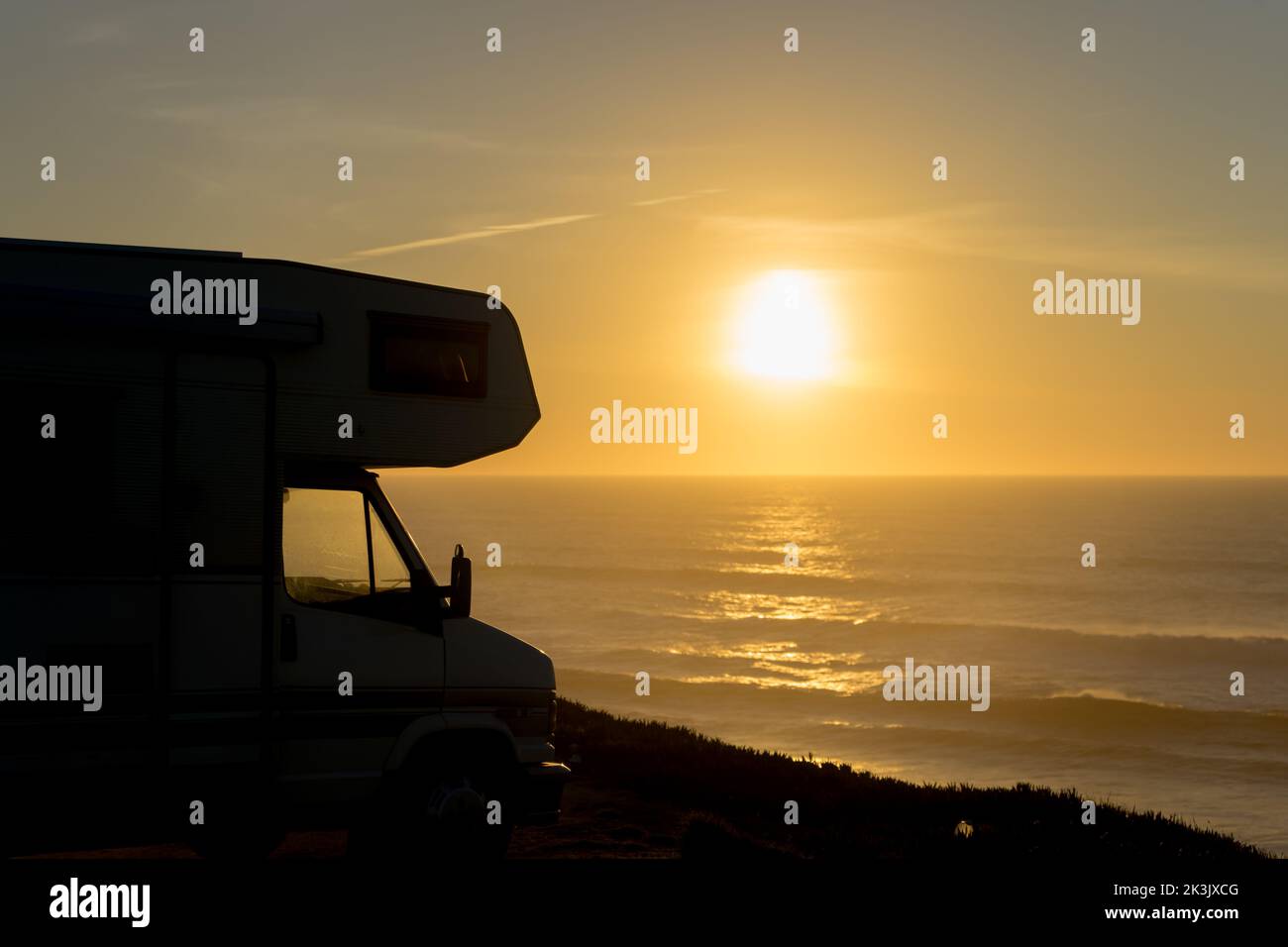Motorhome by the beach at sunset Stock Photo - Alamy