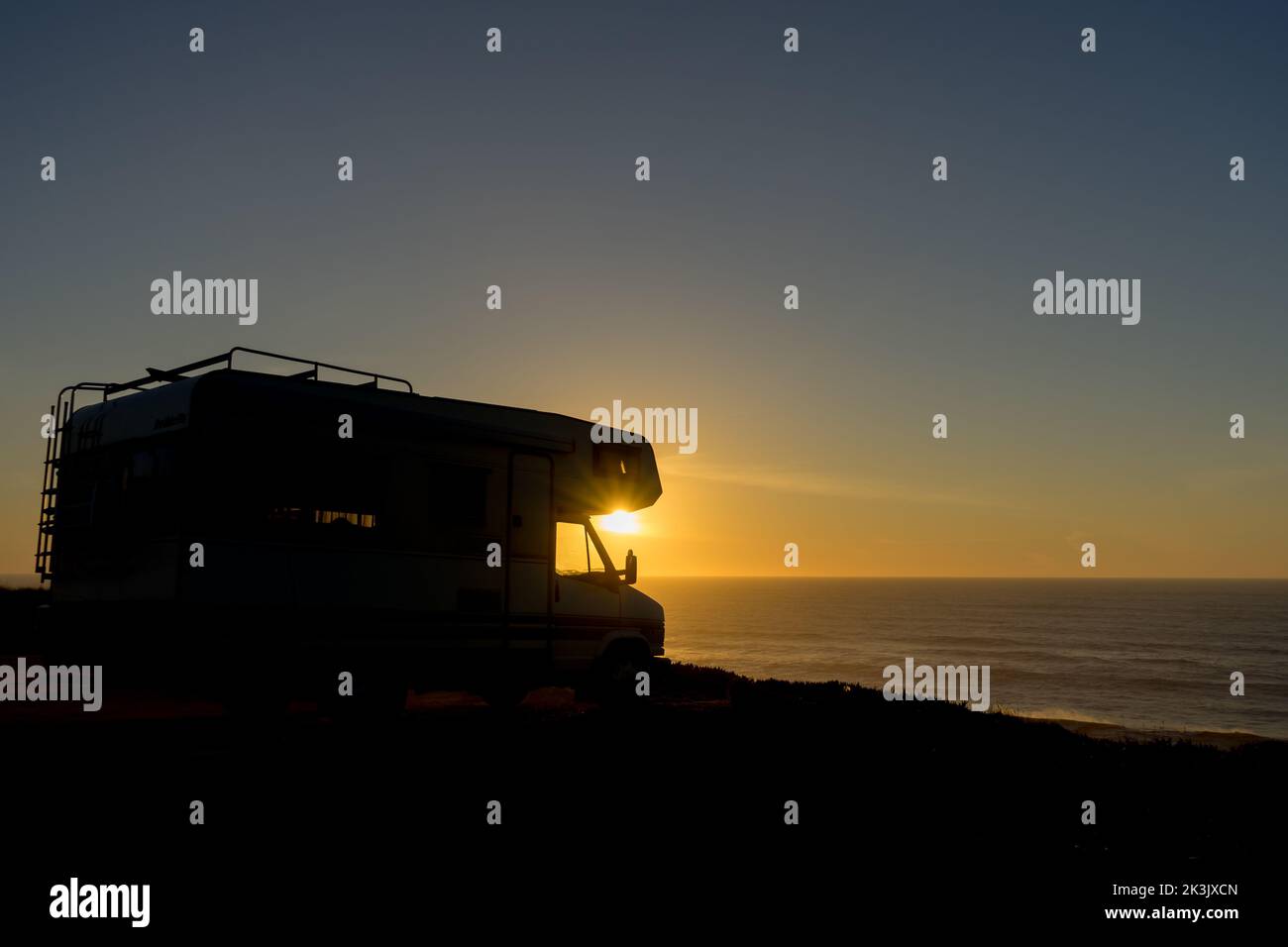 Motorhome by the beach at sunset Stock Photo - Alamy