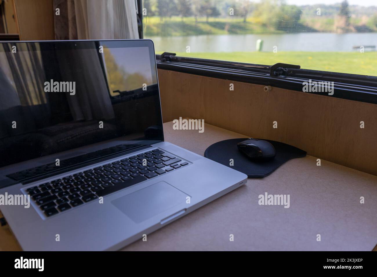 Work desk inside campervan with a lake view Stock Photo - Alamy