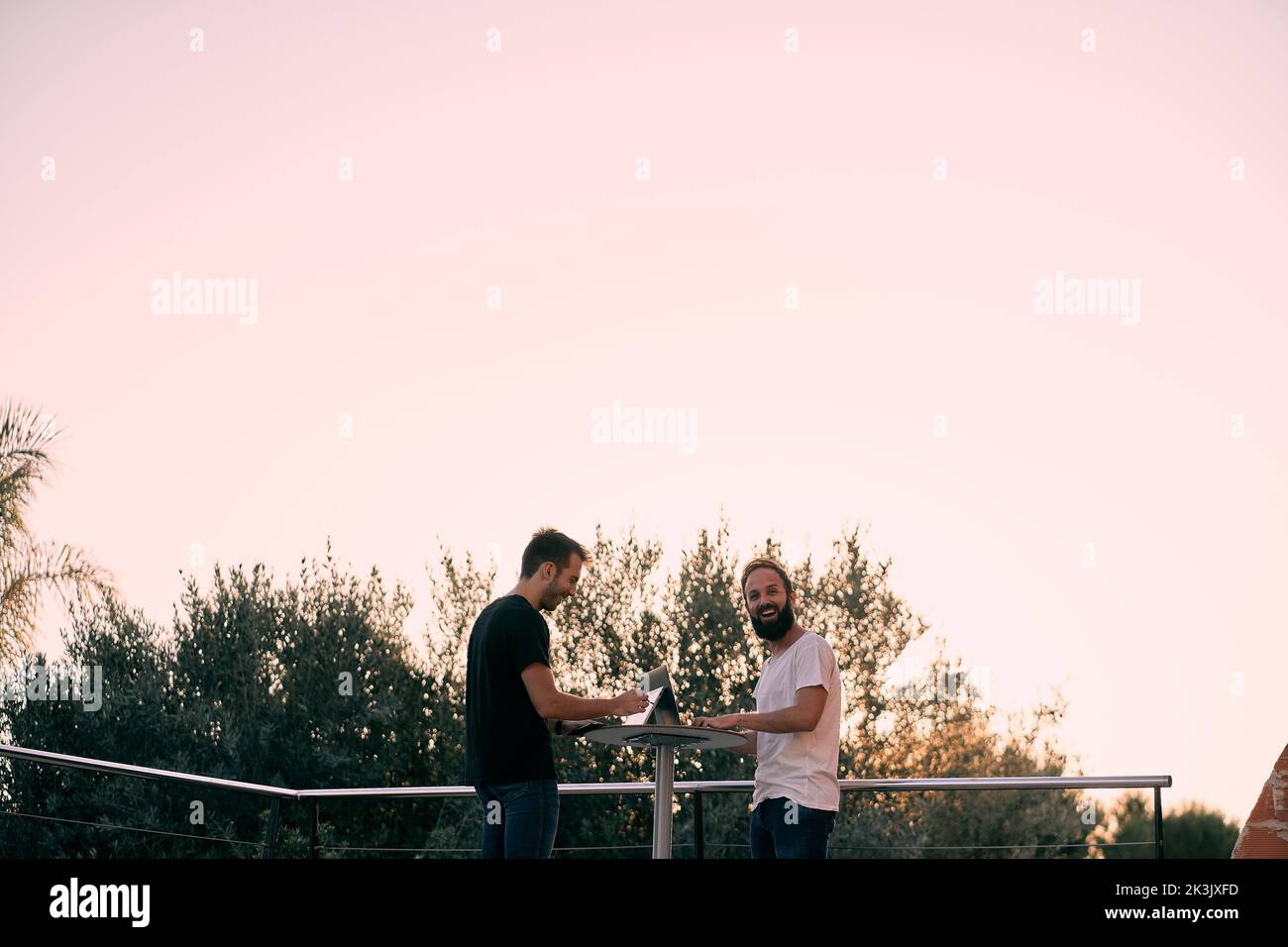 Two young entrepreneur men having a business meeting while working ...