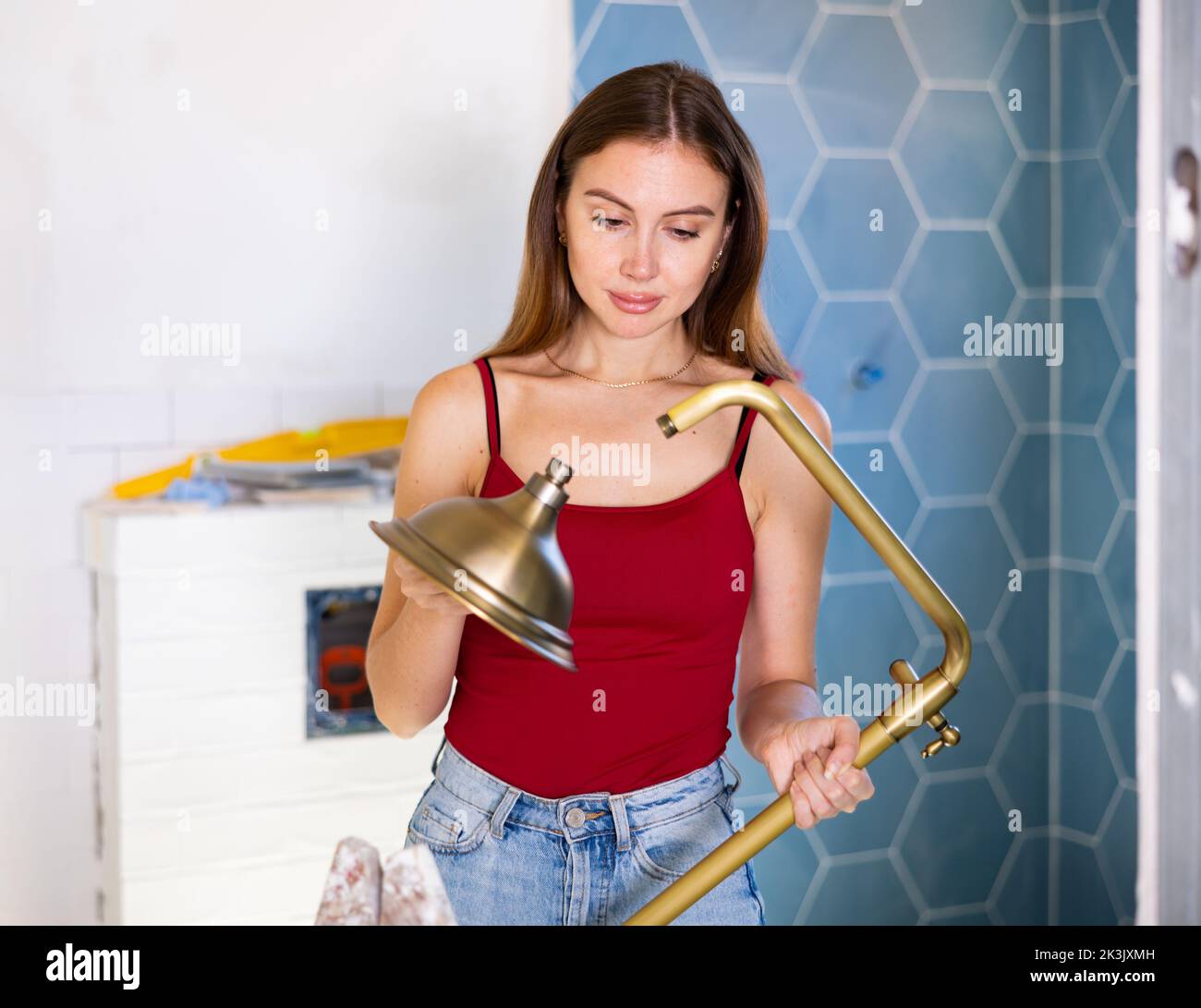 Woman trying on new shower in a bathroom being renovated Stock Photo ...