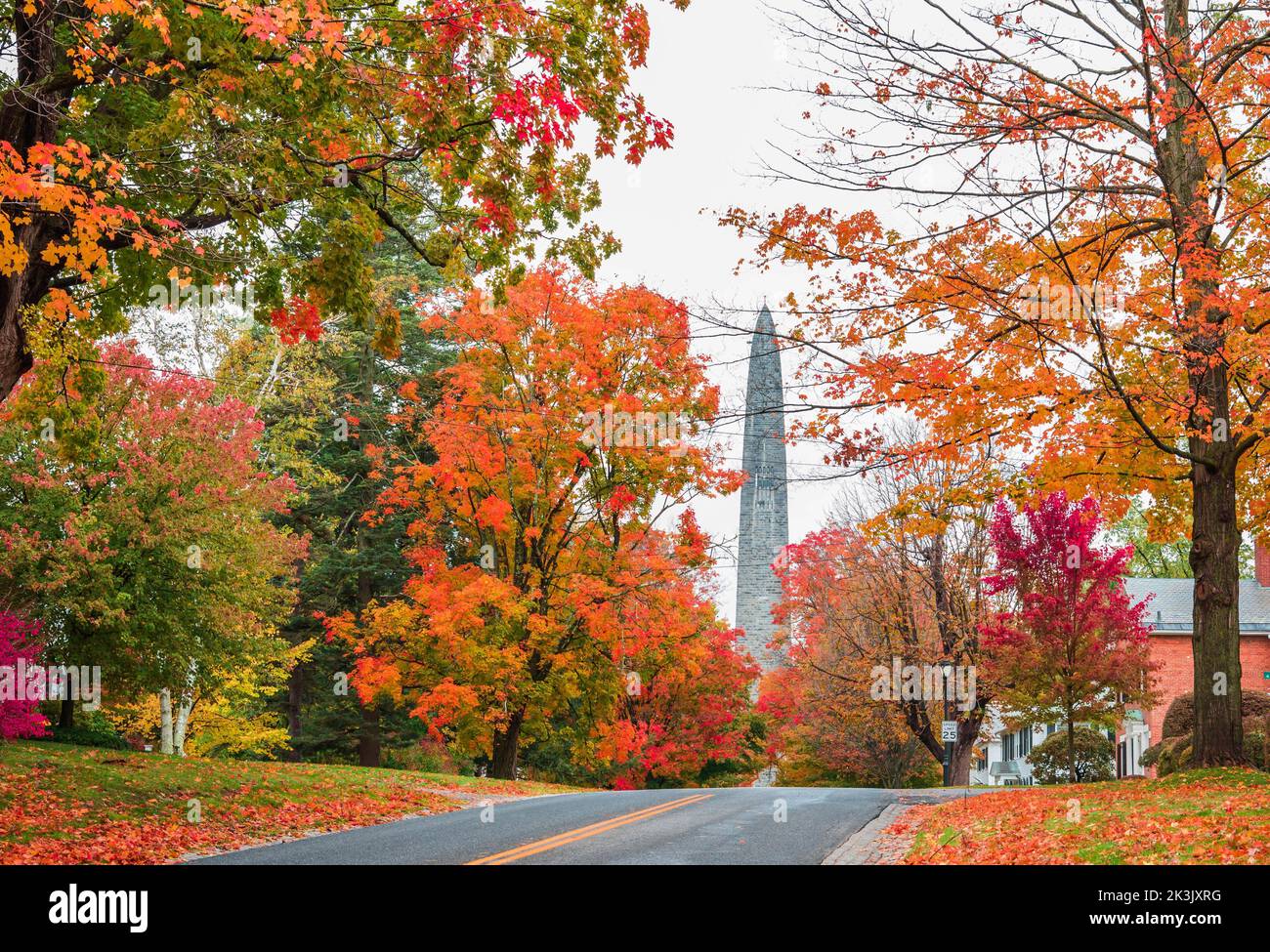 A view of Bennington battle monument Vermont behind a road and colorful ...