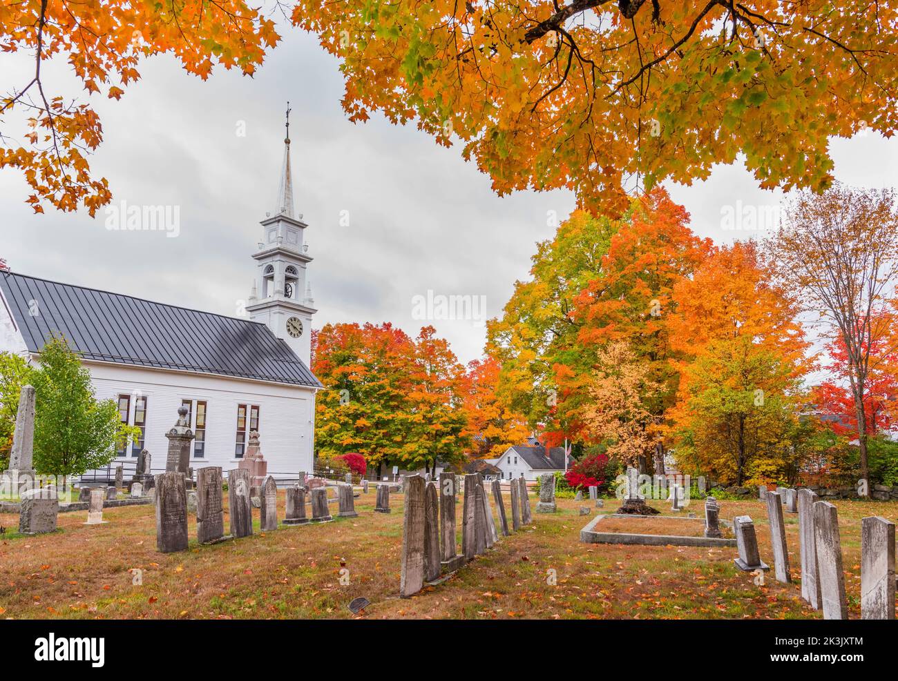 The gravestones of Hampshire cemetery with chapel and colorful trees at ...
