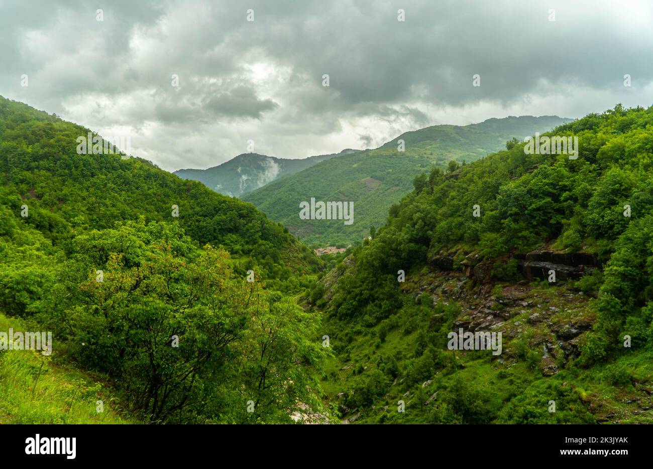 The ranges of greenery mountains under cloudy sky Stock Photo - Alamy