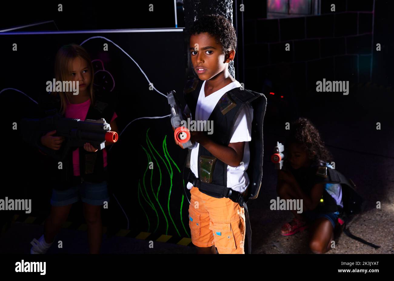 Mulatto playing lasertag with friends Stock Photo - Alamy