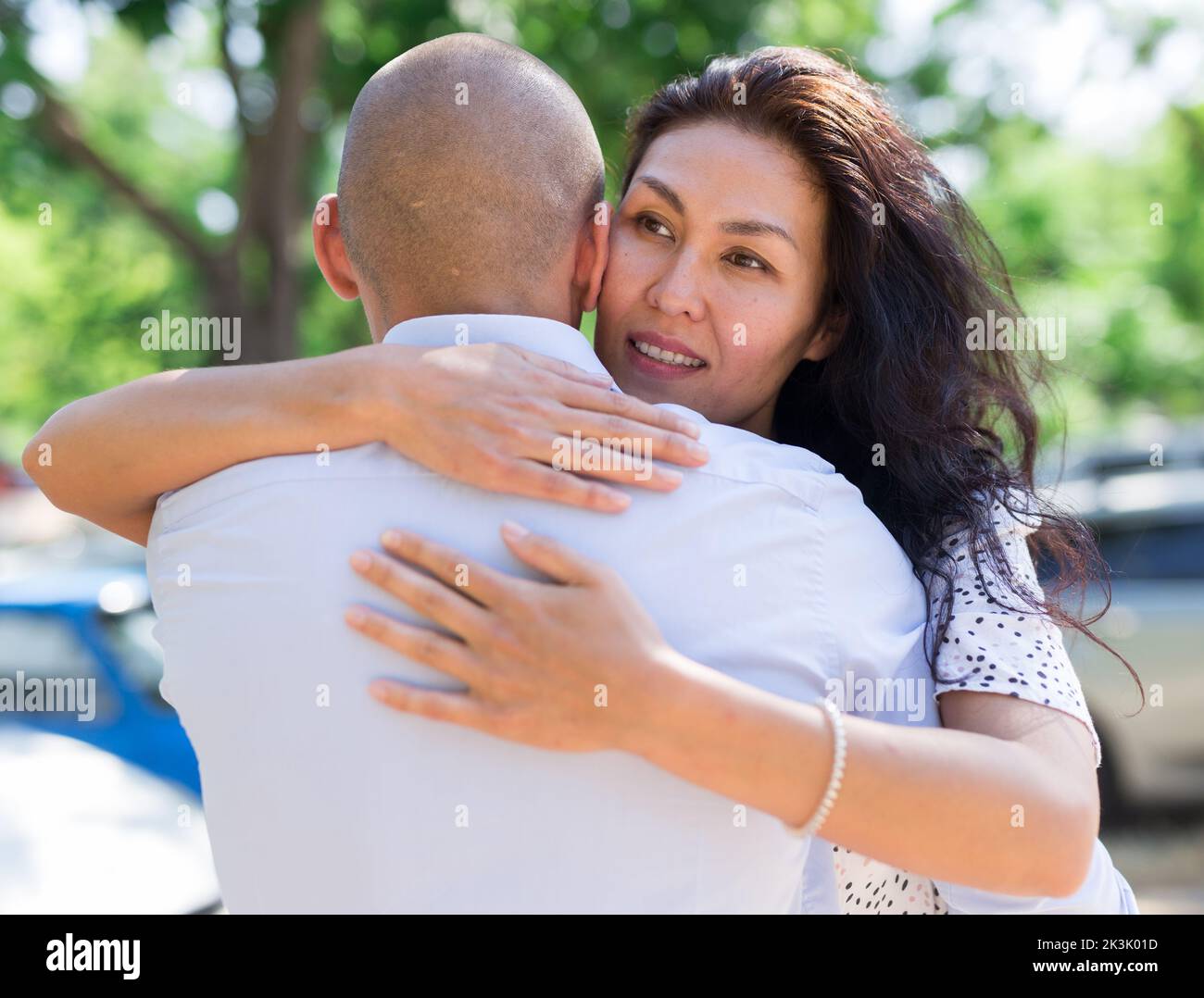 Happy couple reunion in the street Stock Photo - Alamy
