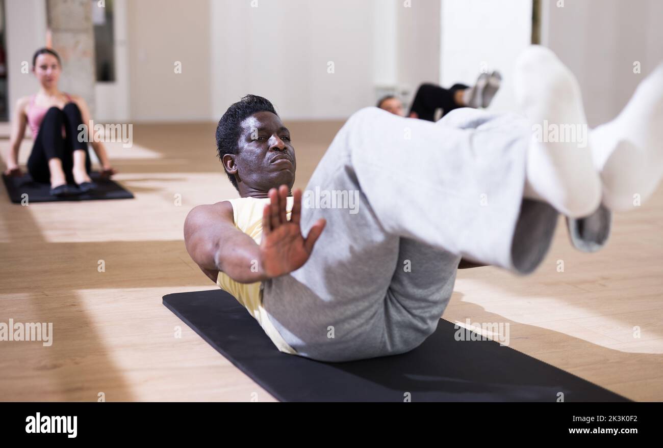 African American exercising during group pilates class Stock Photo - Alamy