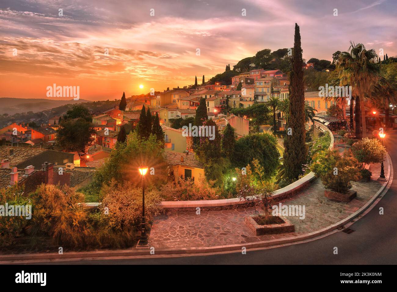 Scenic view of sunset over illuminated village of Bormes-les-Mimosas in ...
