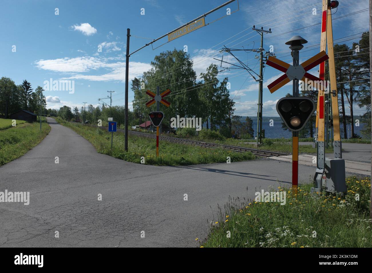 A closeup of Level crossing with a blue sky background Stock Photo - Alamy