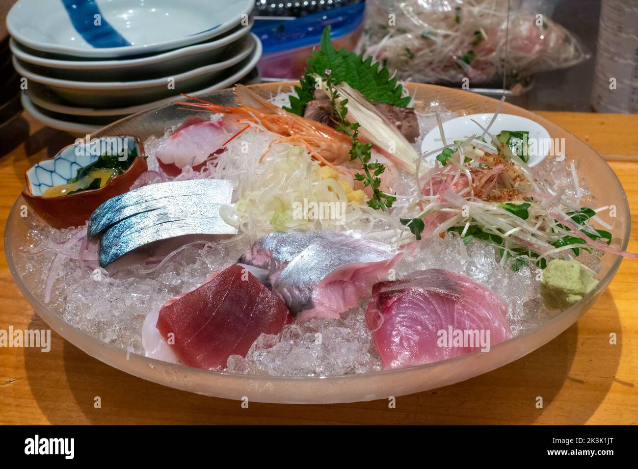 Big glass ice bowl with assorted sashimi pieces. Traditional sashimi ...