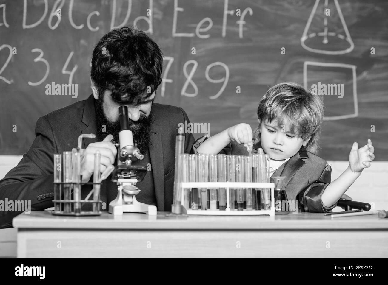 My father is scientist. Teacher bearded man father and child test tubes ...