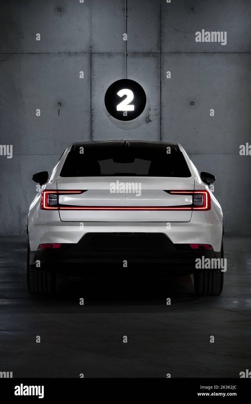 Snow white Polestar 2 tailgate with signature break light in front of a ...