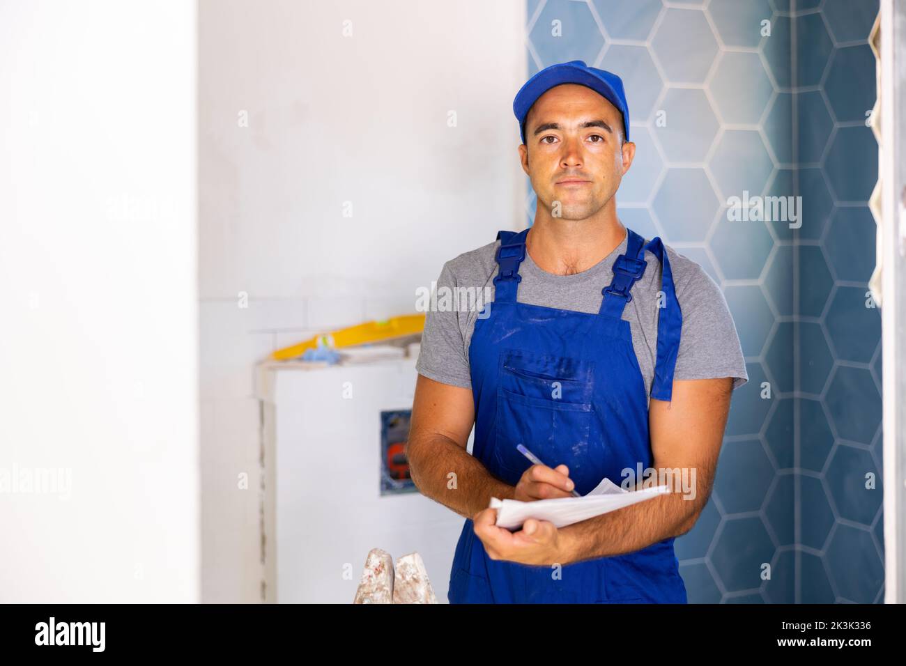 Man with documents planning renovation works in new apartment Stock ...