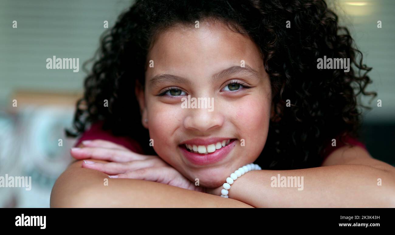 Hispanic preteen girl face smiling at camera. Cute South American kid ...