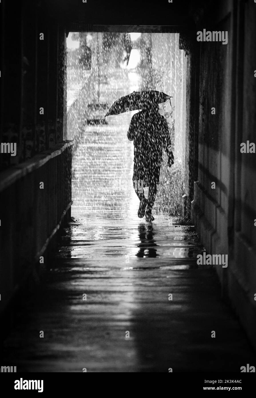 Man walking in rain umbrella hi-res stock photography and images - Alamy