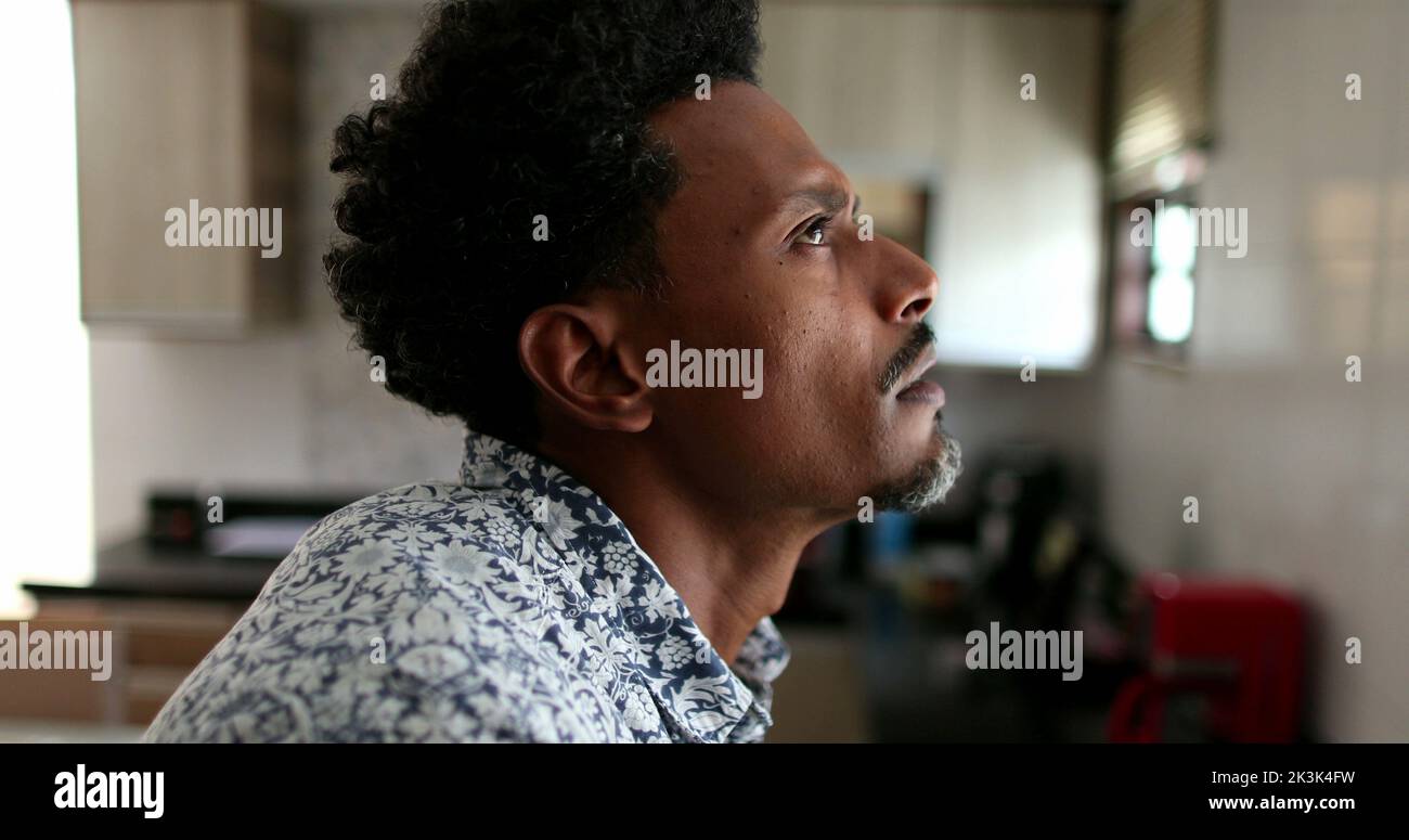 Frustrated Black African man standing in kitchen at home concerned ...
