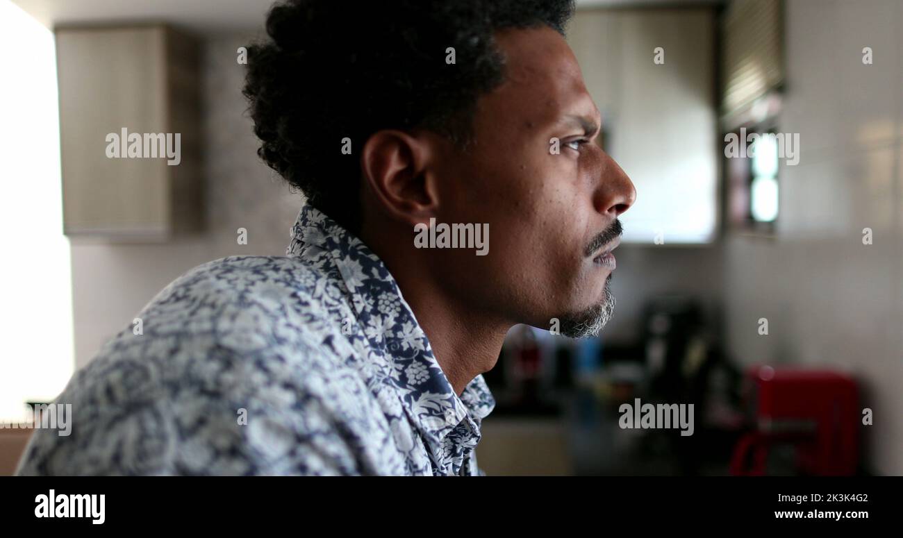 Frustrated Black African man standing in kitchen at home concerned ...