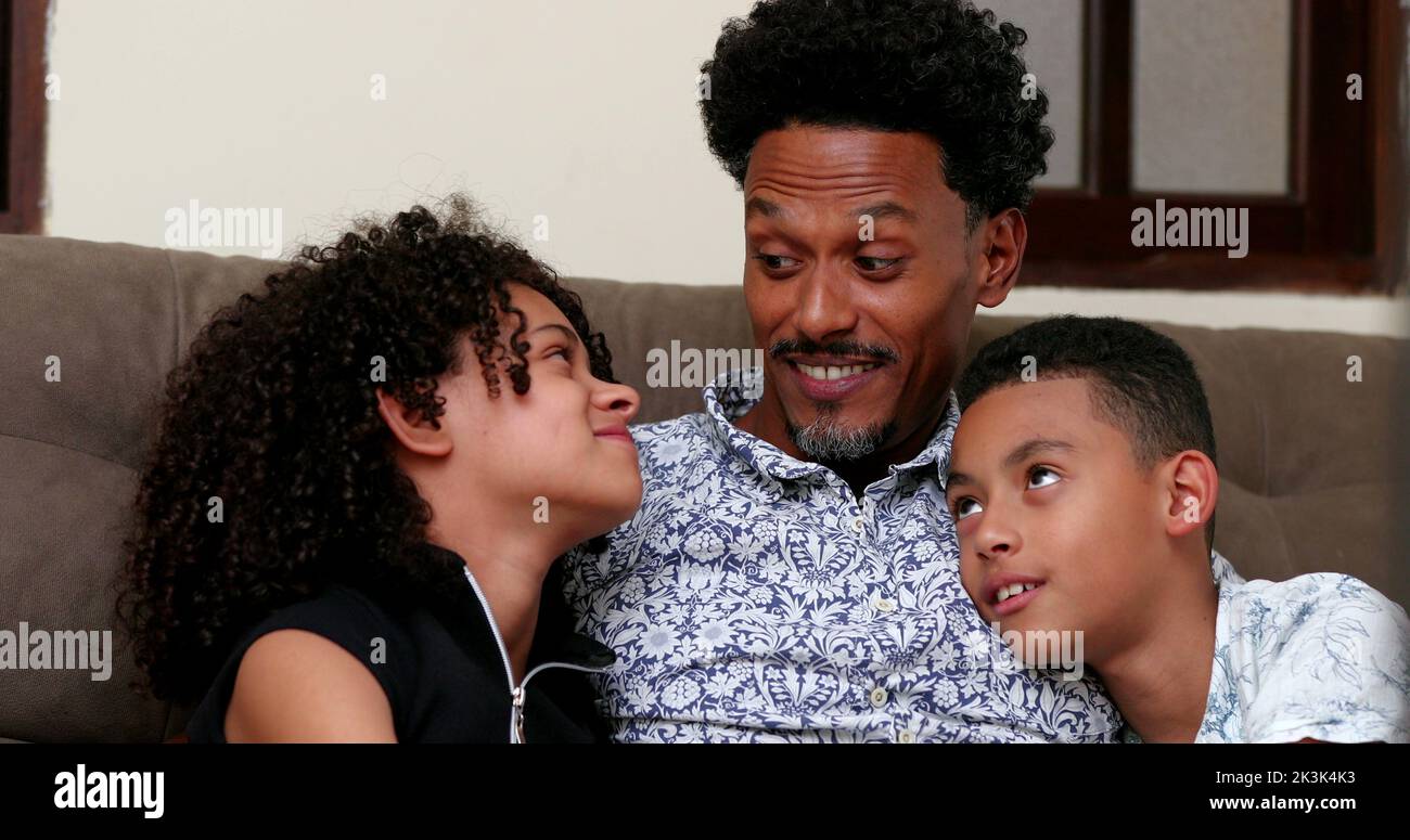 Happy African father and children relationship. Dad talking to daughter ...