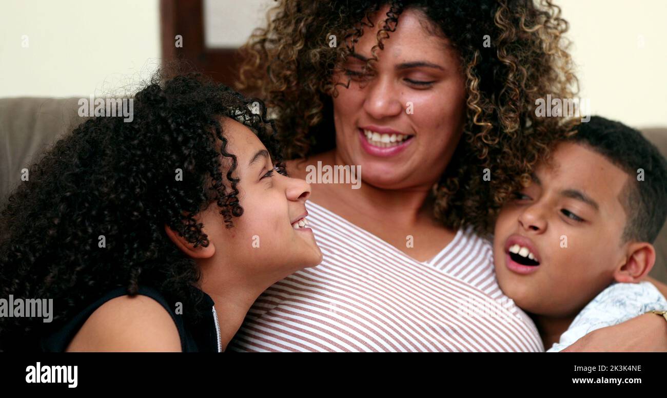 Happy African mother and children relationship. mom kissing and ...