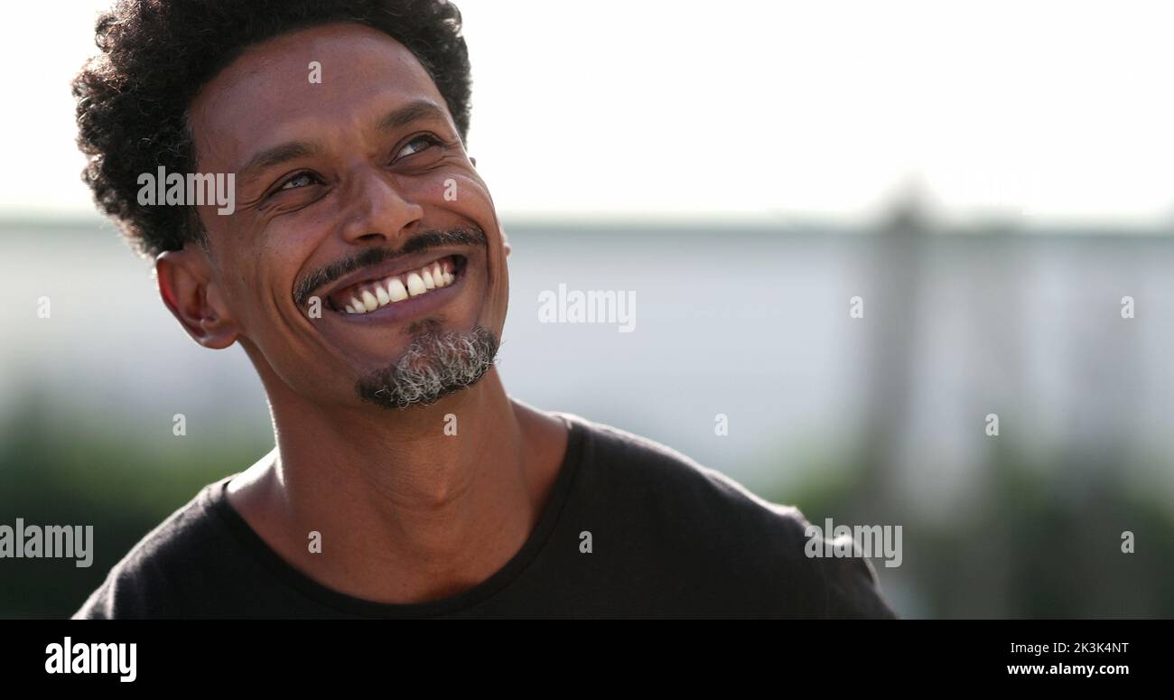 Happy black African man smiling and laughing Stock Photo - Alamy