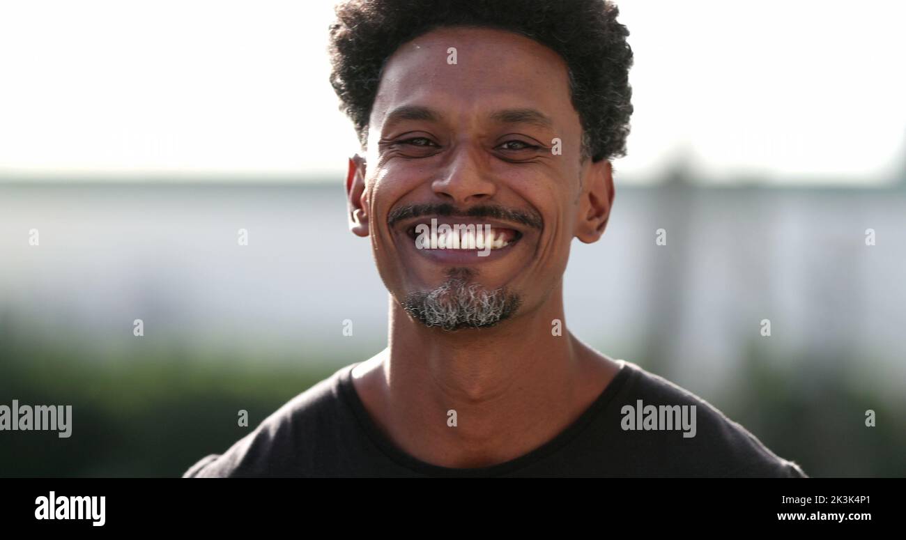 Happy black African man smiling and laughing Stock Photo - Alamy