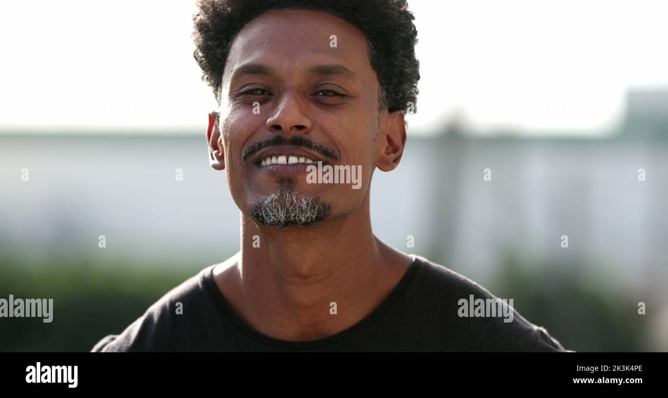 Happy black African man smiling and laughing Stock Photo - Alamy