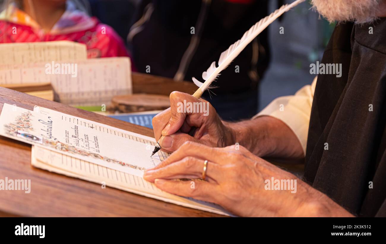 Hands writing a letter with a plume, Calligrapher writing with a ...