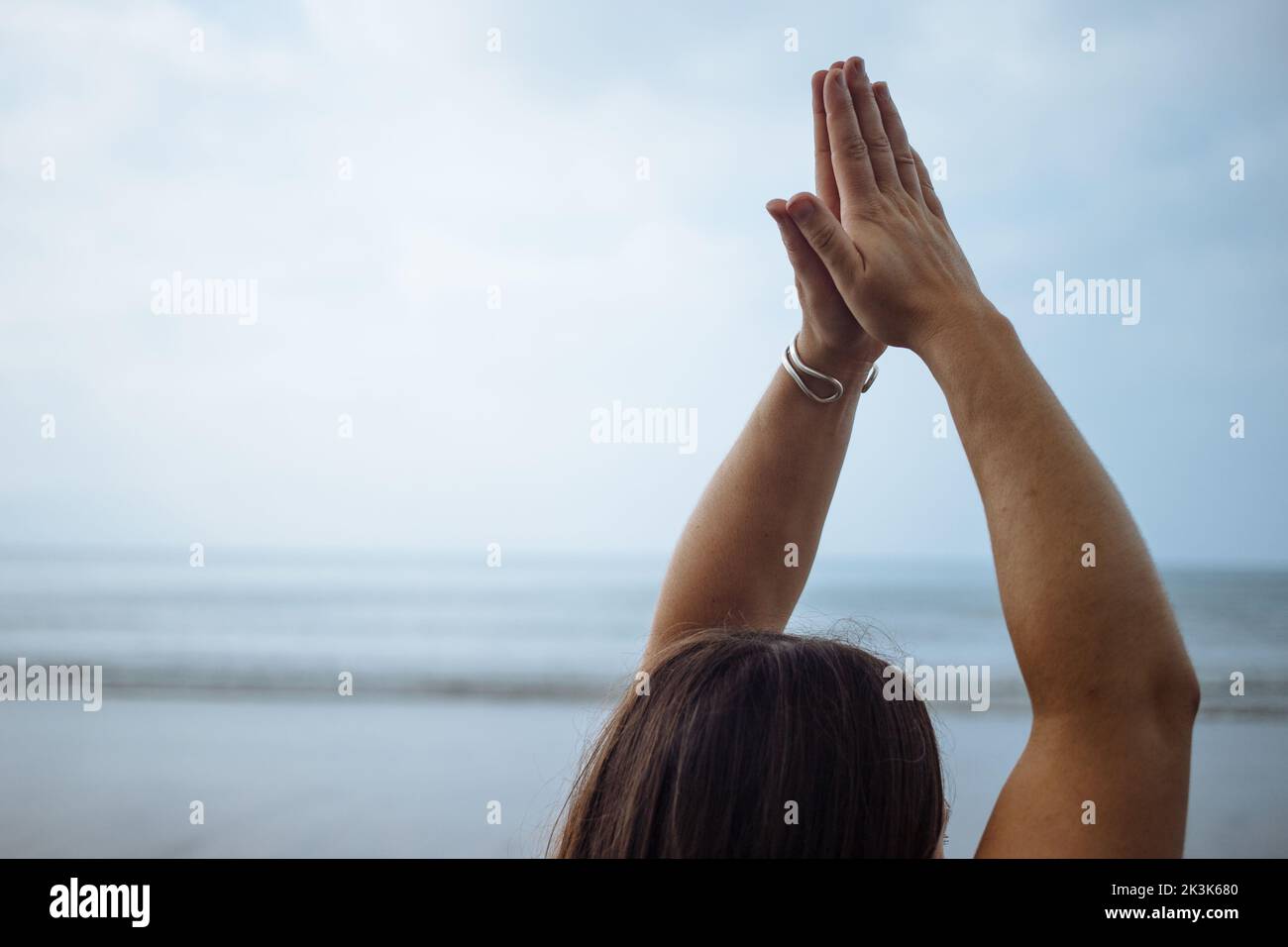 A close up of a woman doing Yoga Salutation at the beach Stock Photo ...