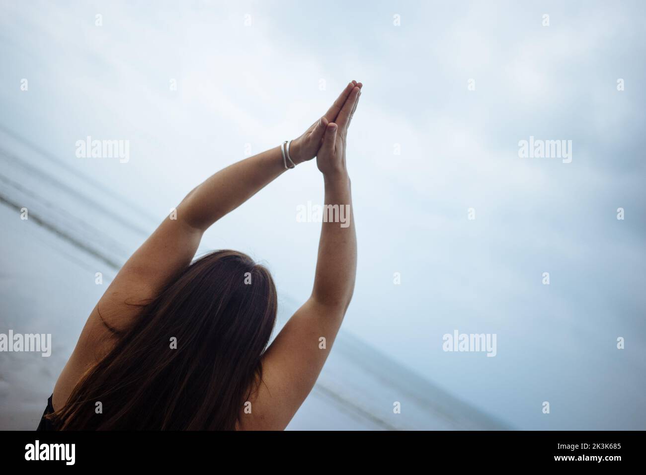 A close up of a woman doing Yoga Salutation at the beach Stock Photo ...