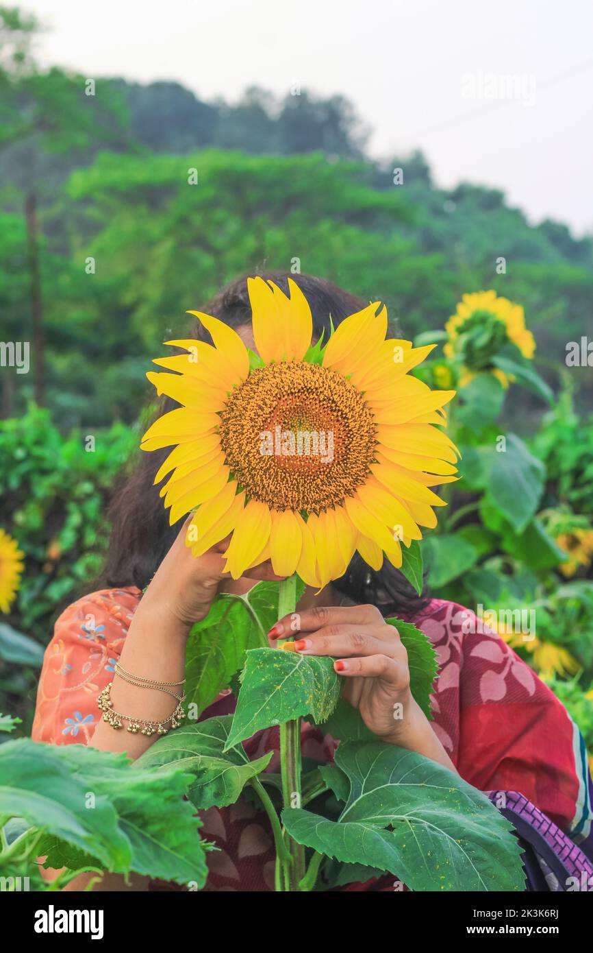 Beautiful young girl enjoying nature on the field of sunflowers. Girl ...