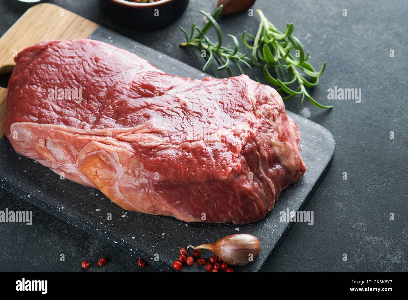 Steaks. Fresh New York Steaks raw with spices rosemary and pepper on ...